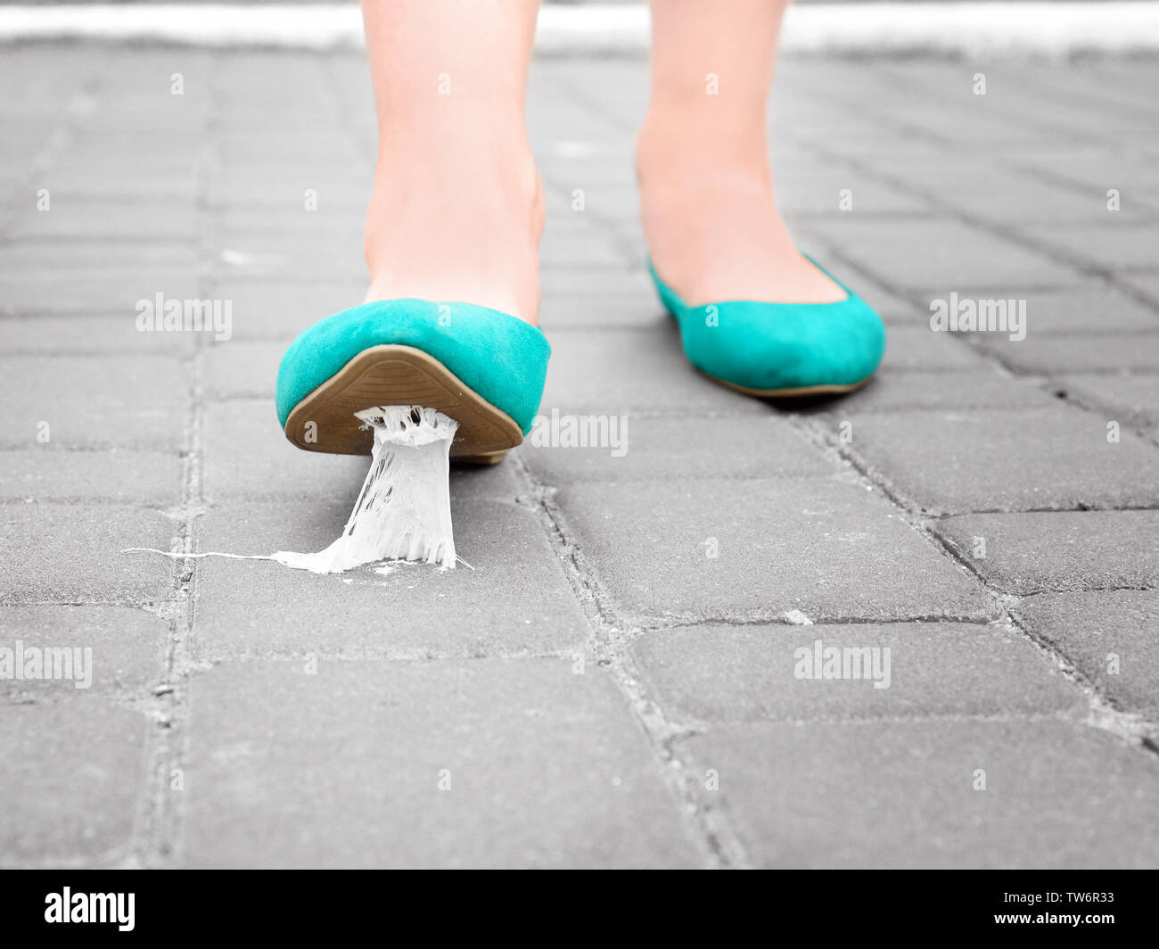 Female foot stuck into chewing gum on street. Concept of stickiness ...