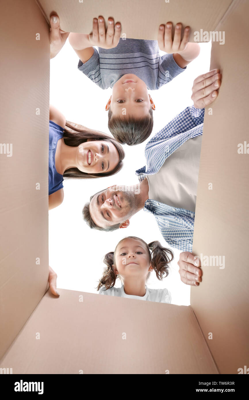 Happy family looking into cardboard box Stock Photo - Alamy