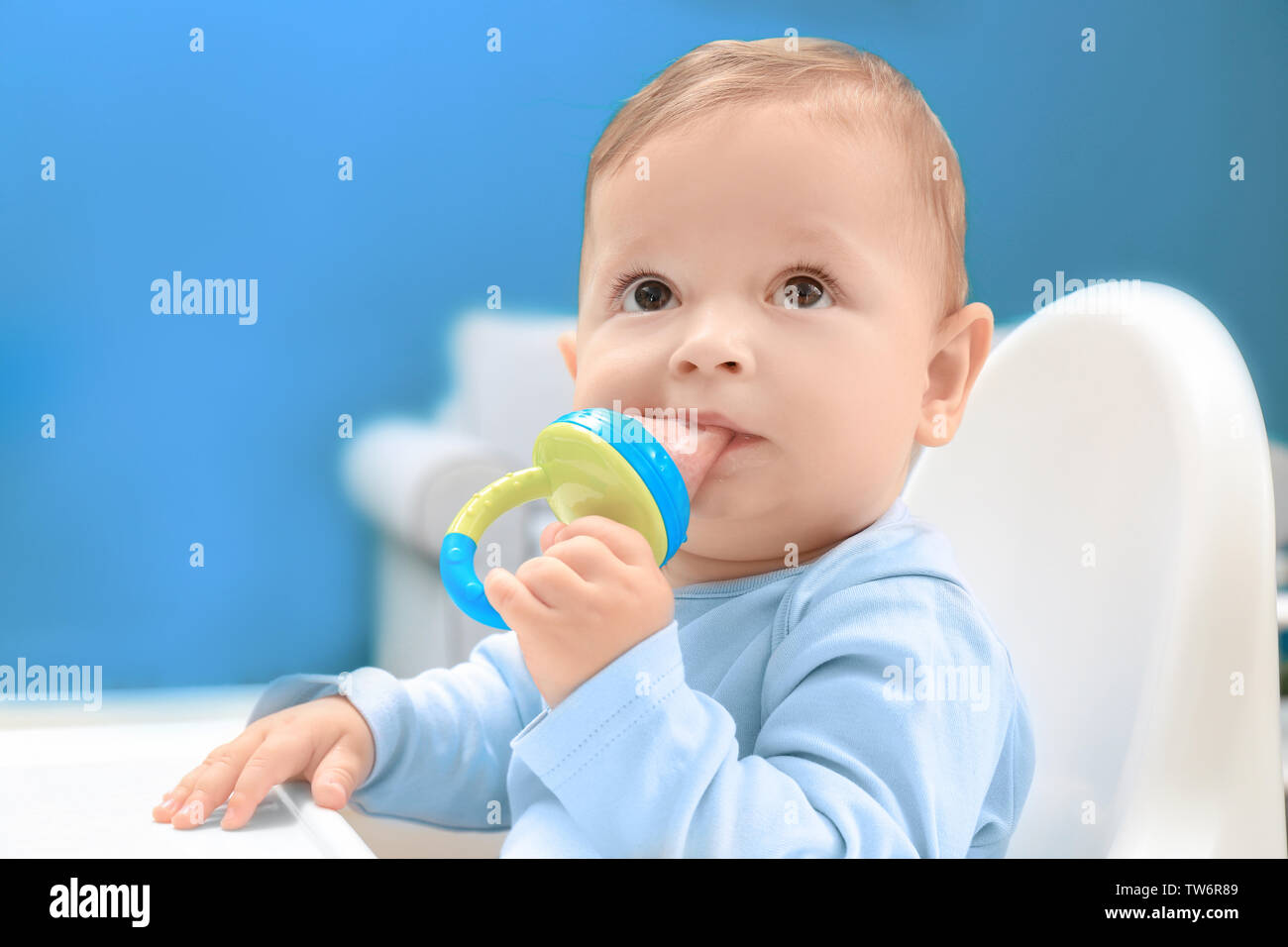 Cute little baby with nibbler at home Stock Photo - Alamy