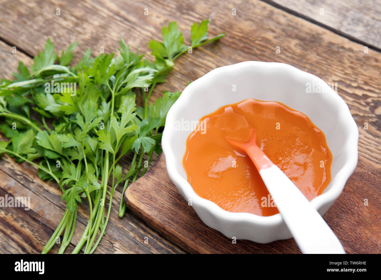 Dish with baby food on wooden table Stock Photo - Alamy