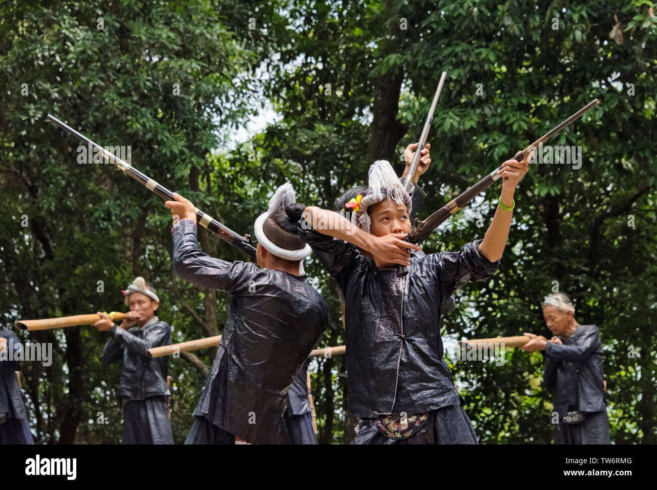 Basha Miao men in traditional clothing firing guns, Guizhou Province ...