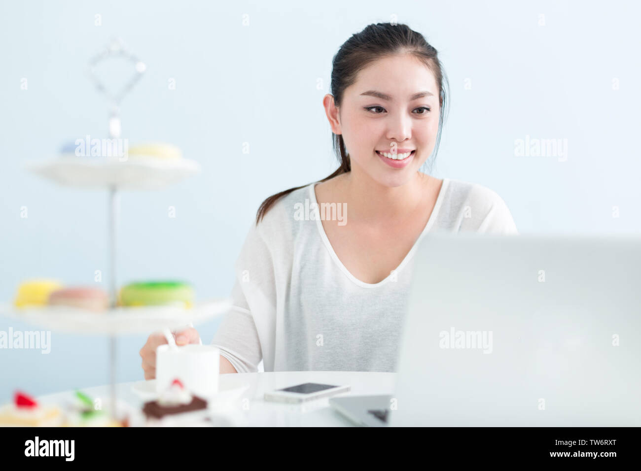 young pretty chinese woman working with laptop in office Stock Photo ...