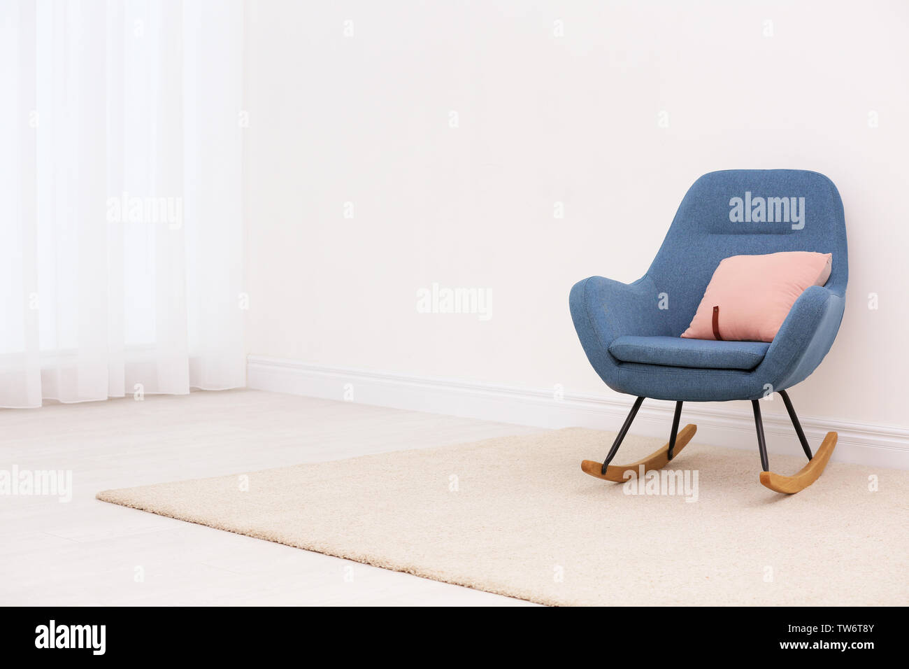 Interior of beautiful room with rocking chair and light carpet Stock ...