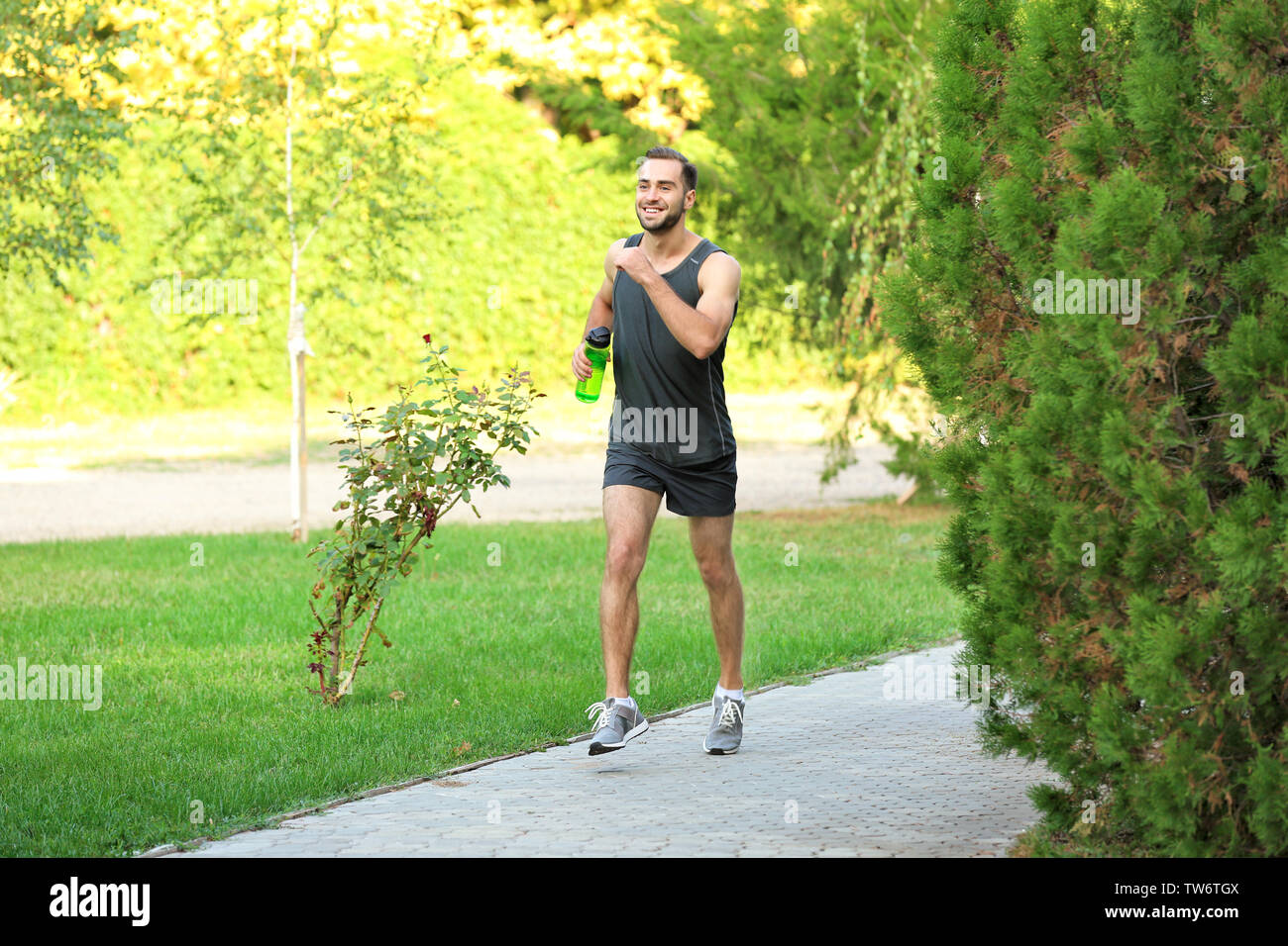 Young man running in park hi-res stock photography and images - Alamy