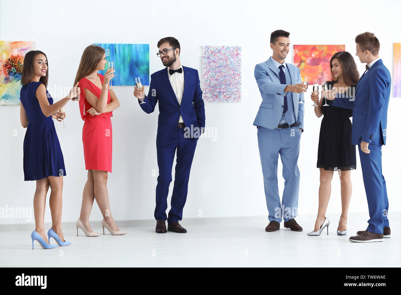 Group of people in formal wear at art gallery exhibition Stock Photo ...