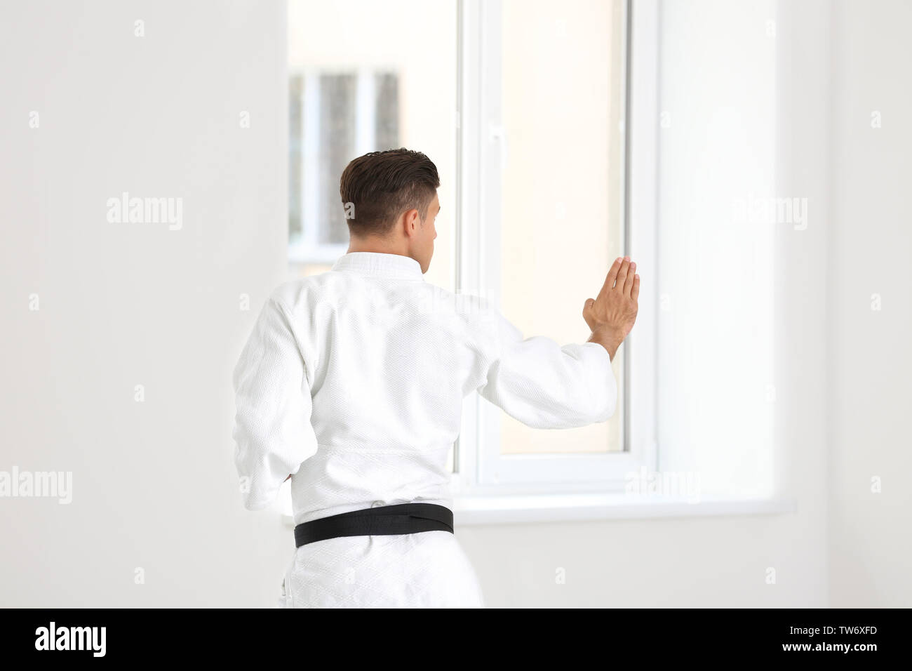 Man practicing karate indoors Stock Photo - Alamy