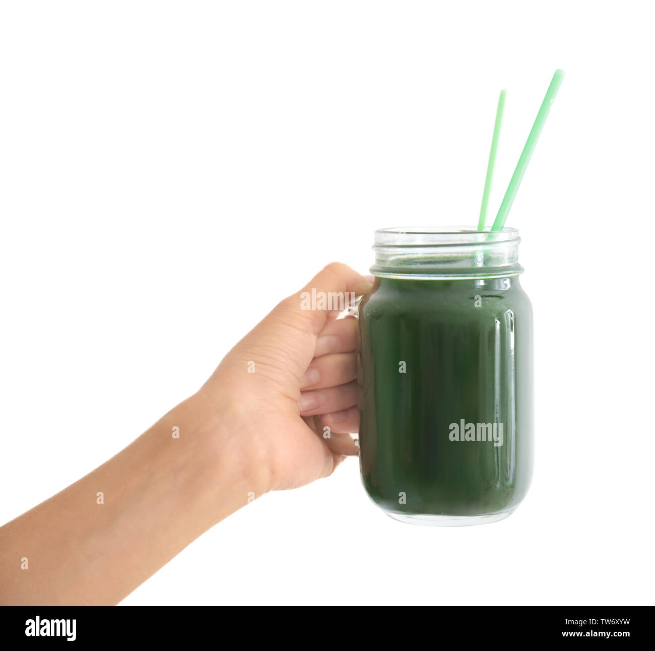 Woman's hand holding mason jar with spirulina drink on white background ...