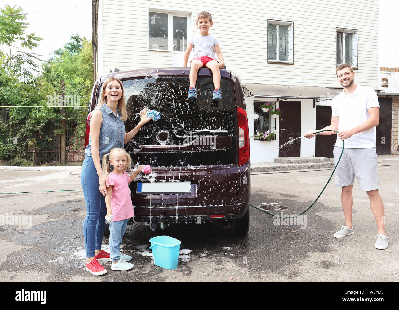 Happy family washing car outdoors Stock Photo - Alamy