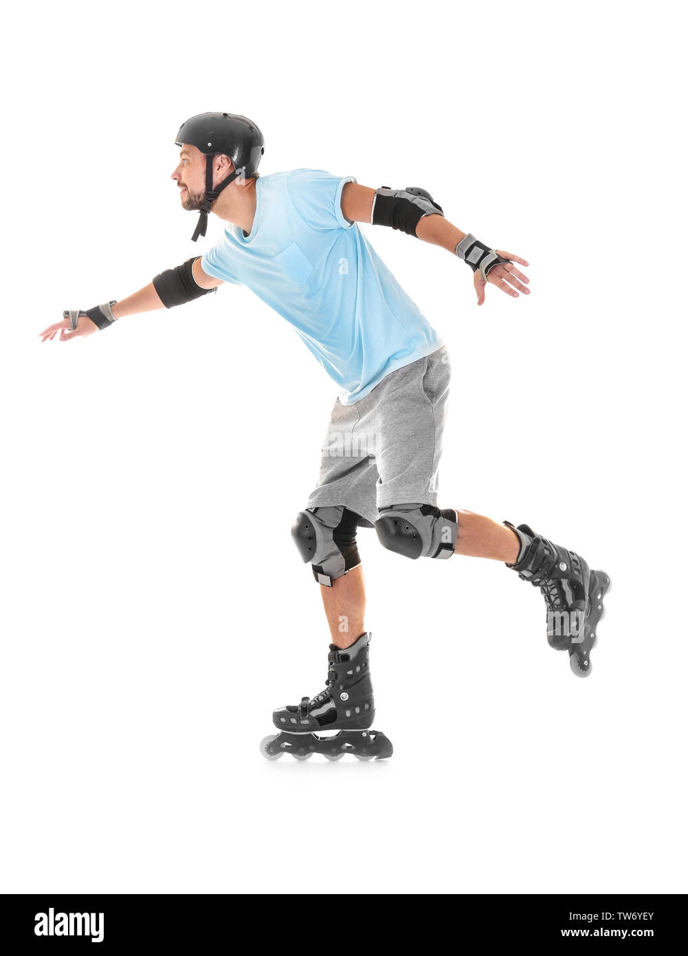 Handsome man on roller skates against white background Stock Photo - Alamy