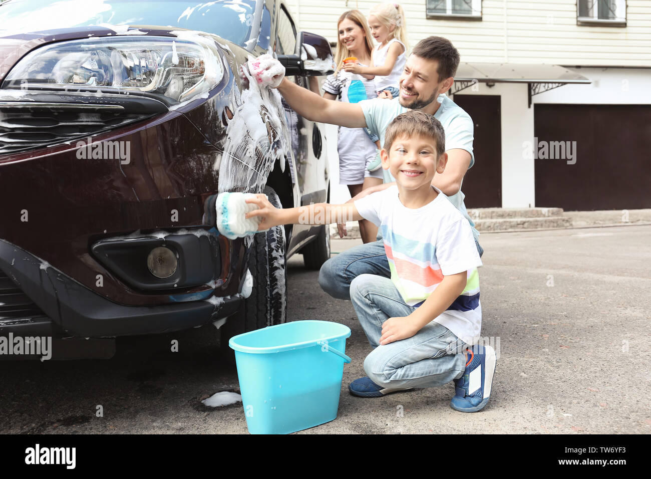 Happy family washing car outdoors Stock Photo - Alamy