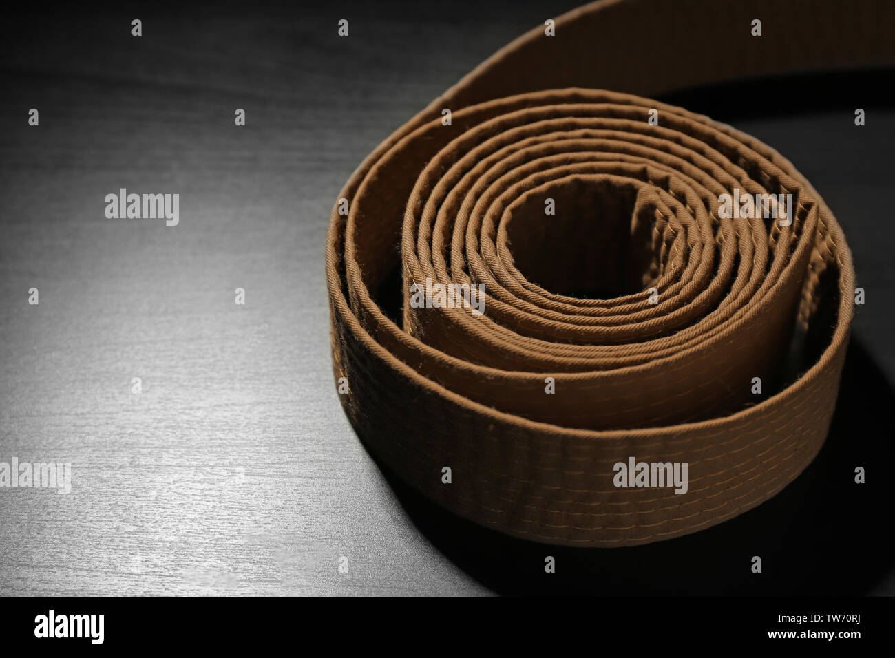 Brown karate belt on dark background Stock Photo - Alamy