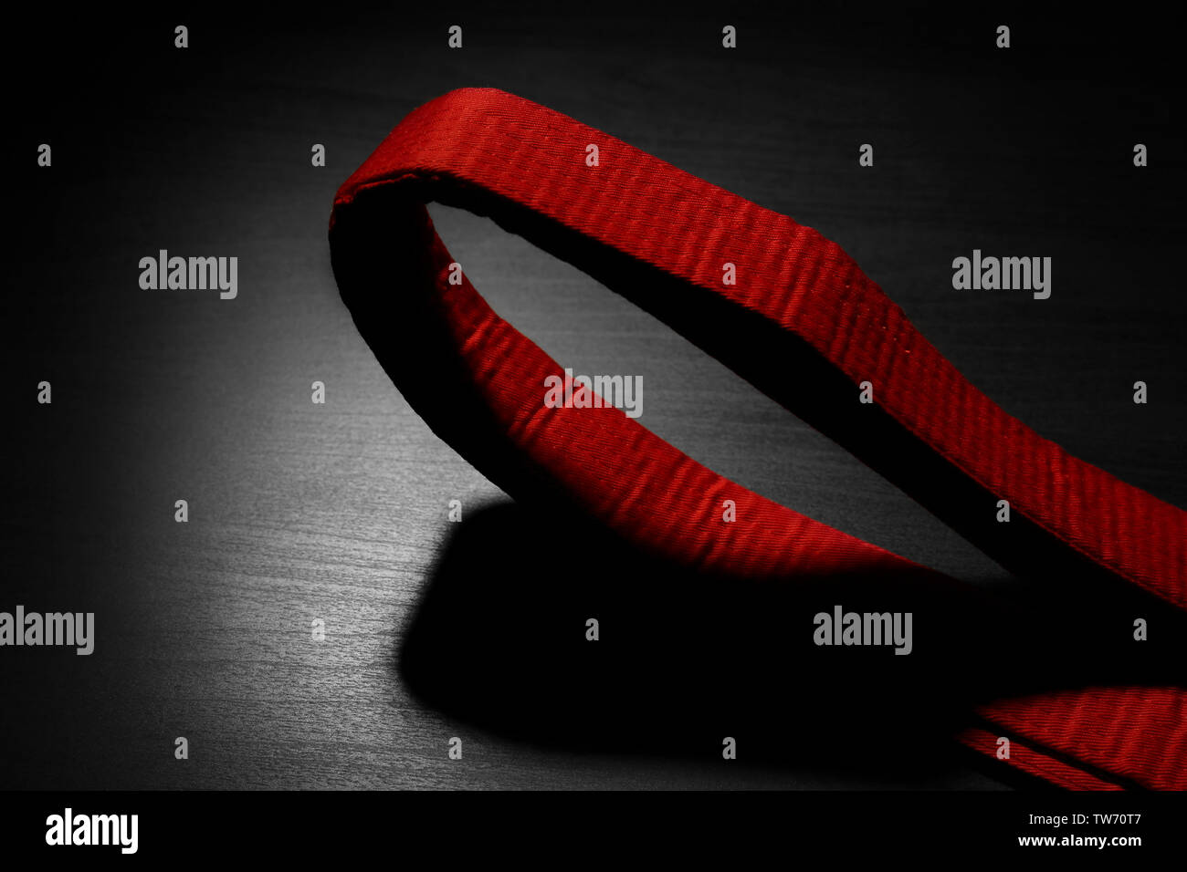 Red karate belt on dark background Stock Photo - Alamy