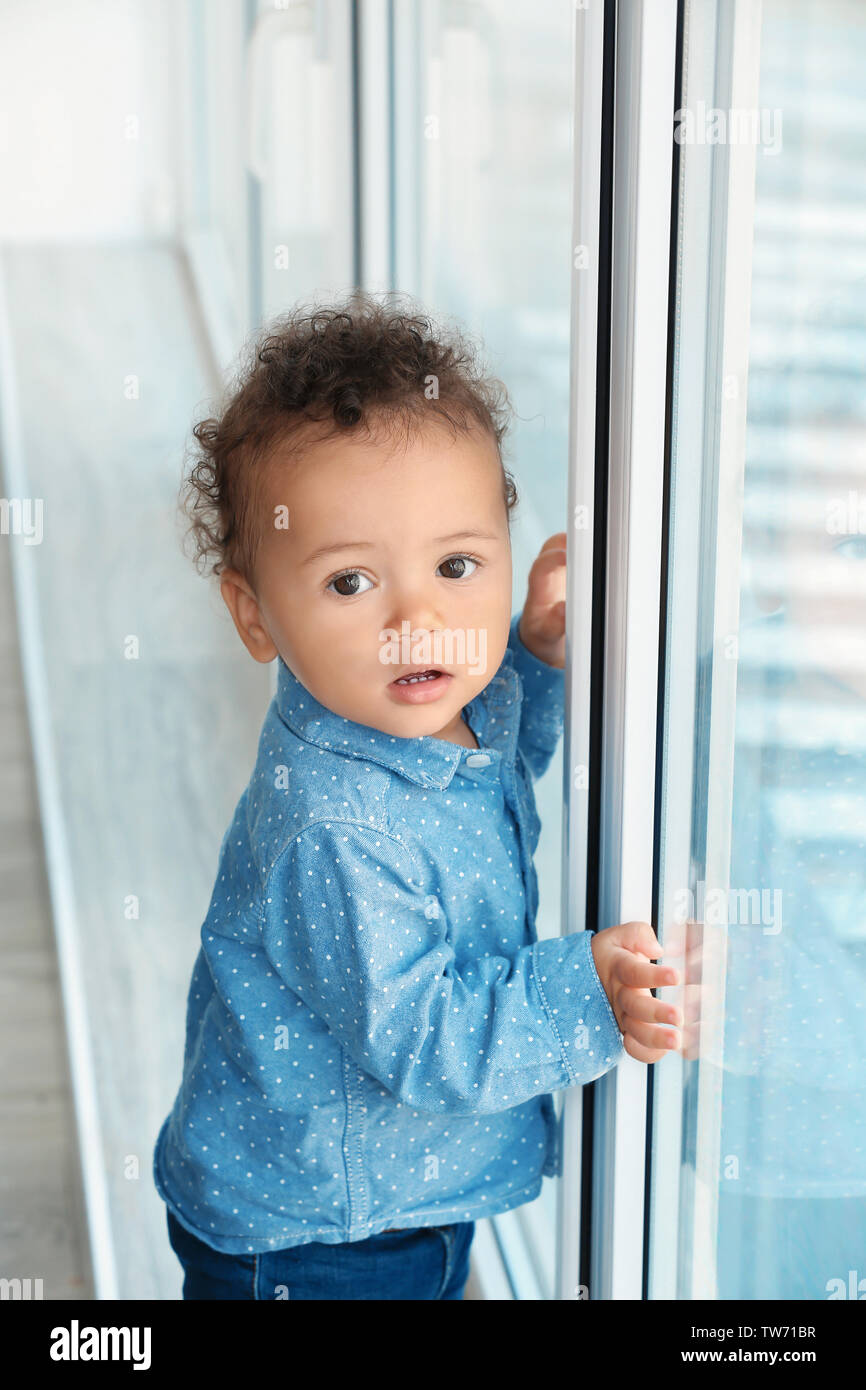 Cute little baby near window at home Stock Photo - Alamy