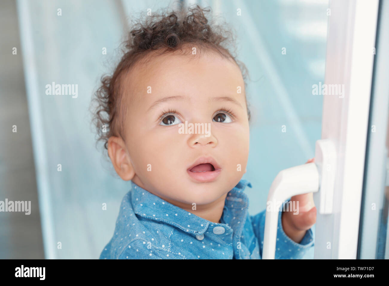 Cute little baby near window at home Stock Photo - Alamy