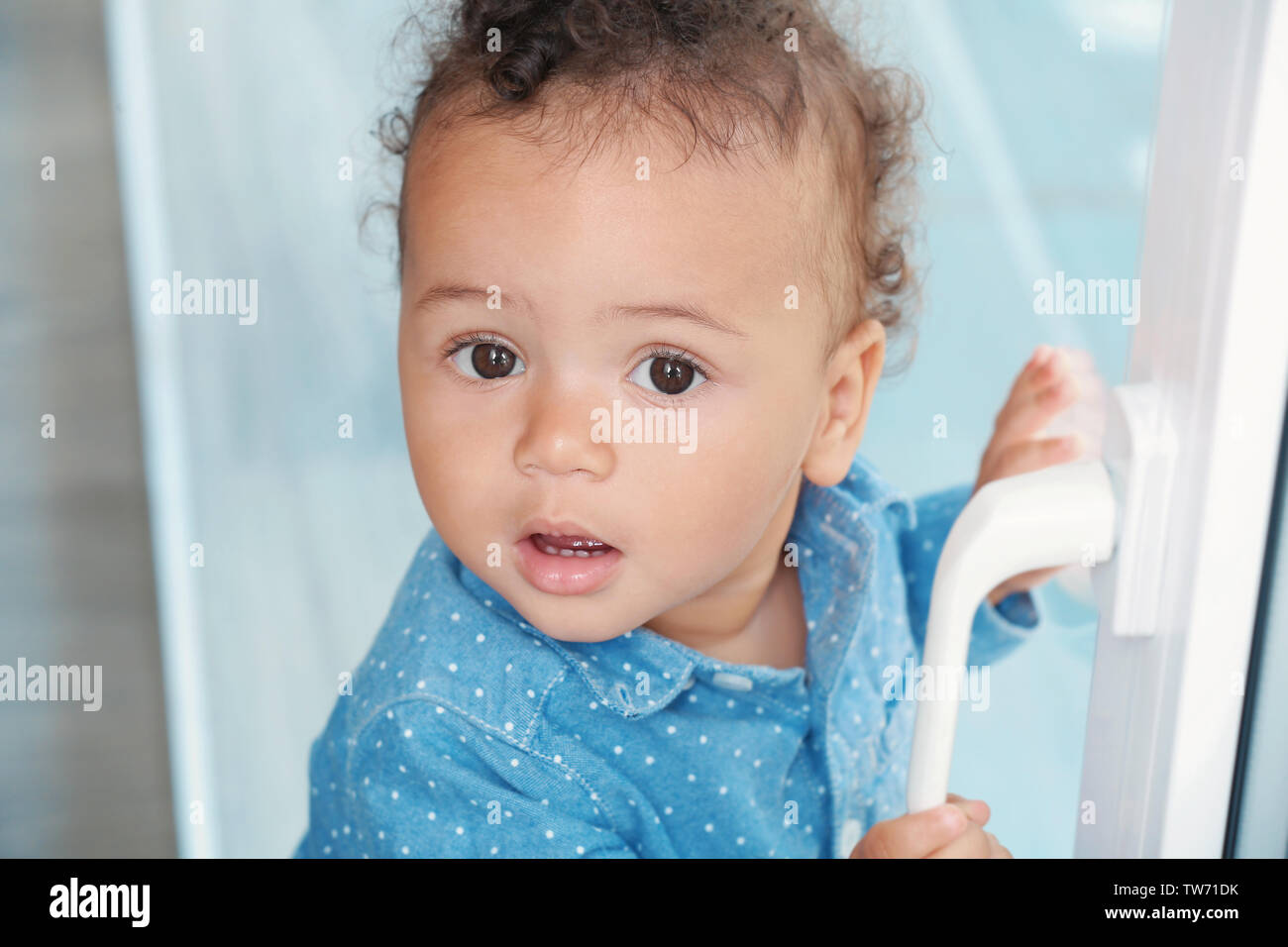 Cute little baby near window at home Stock Photo - Alamy