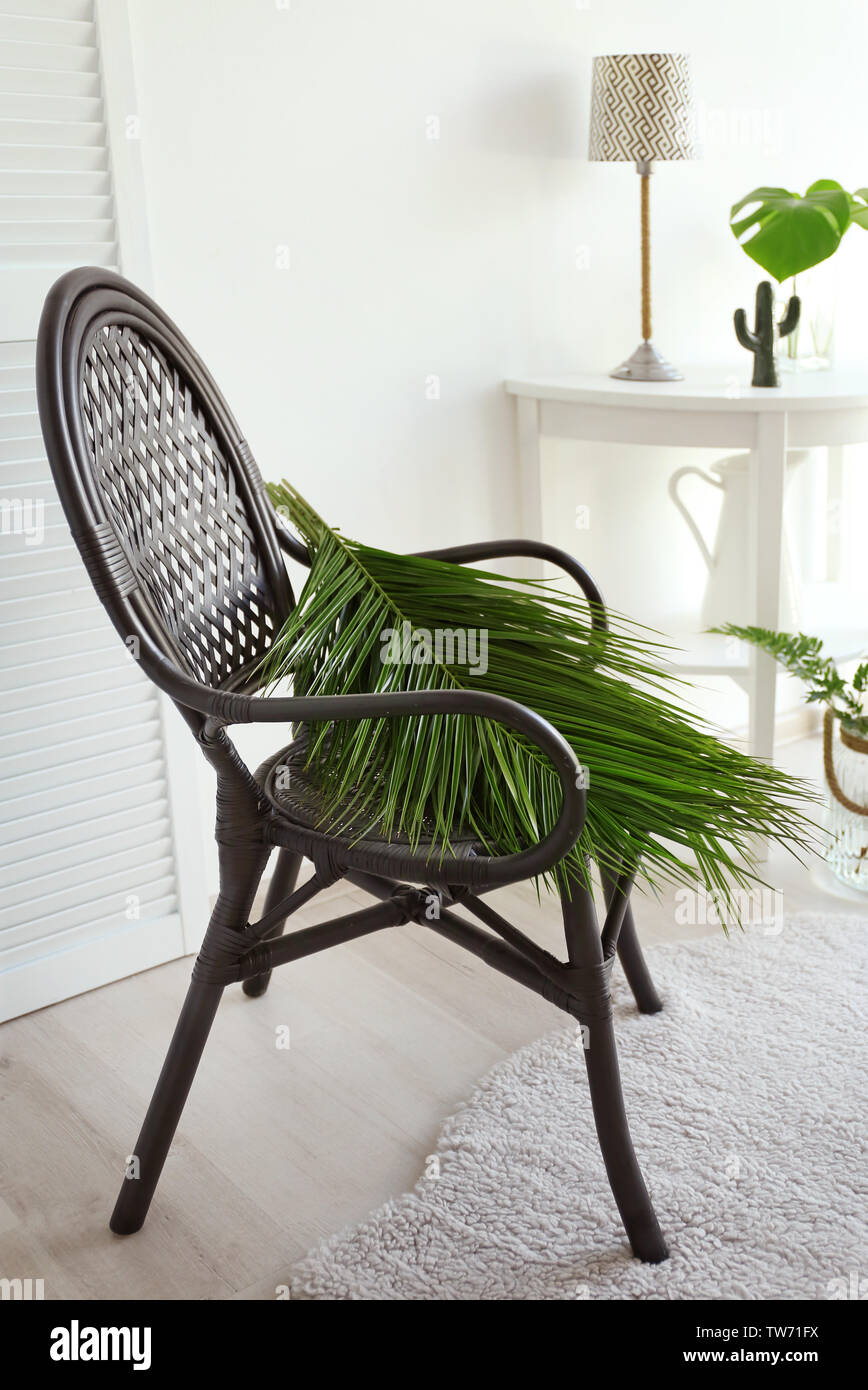 Palm leaves on chair indoors Stock Photo - Alamy