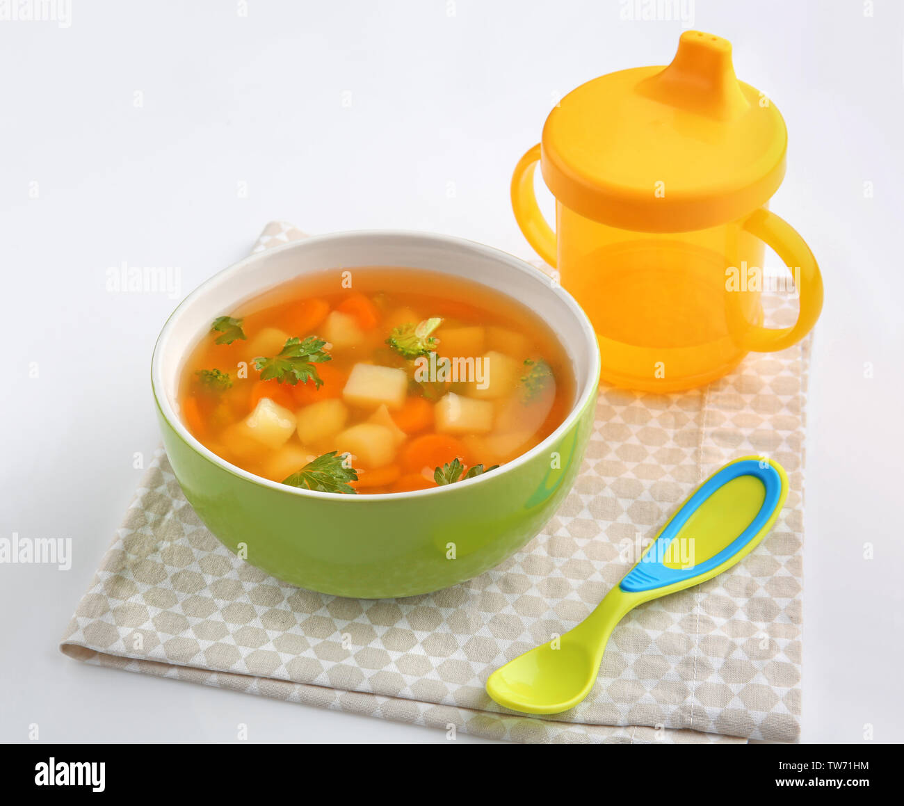 Composition with soup for baby on white background Stock Photo - Alamy