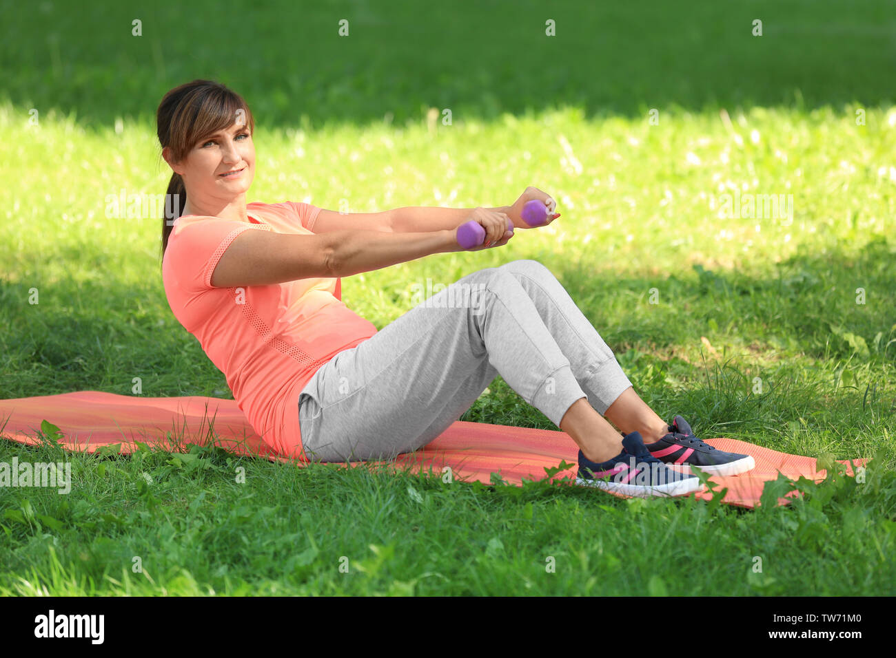 Woman exercises green dumbbells hi-res stock photography and images - Alamy