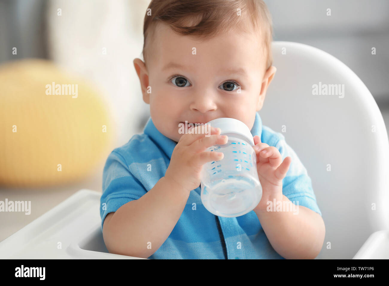 Cute baby drinking water indoors Stock Photo - Alamy