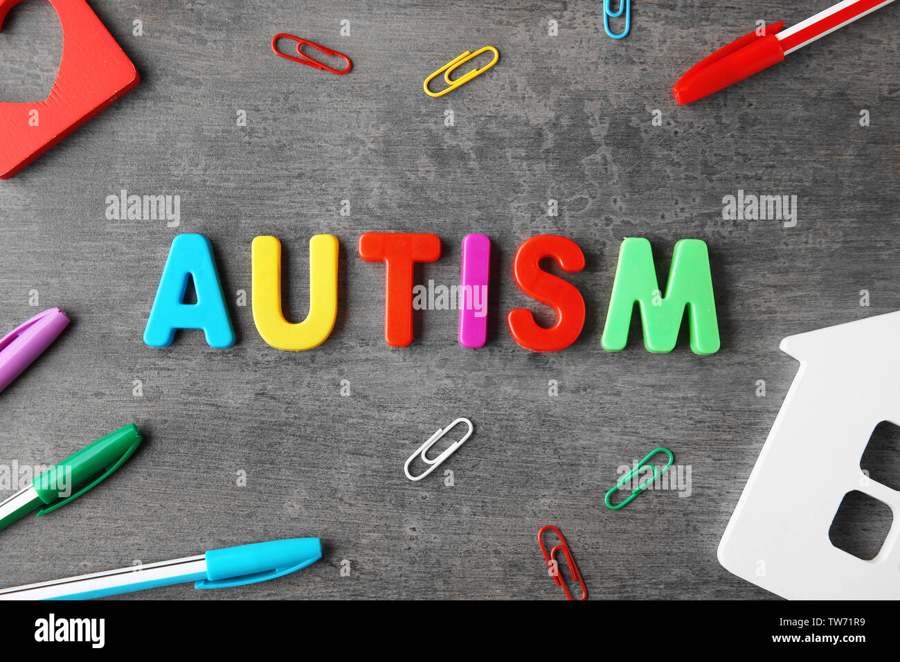 Word "Autism" on grey background Stock Photo - Alamy
