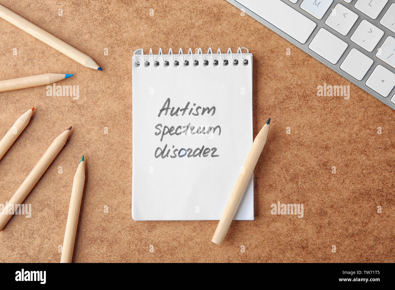Words "Autism spectrum disorder" written in notebook on table Stock ...