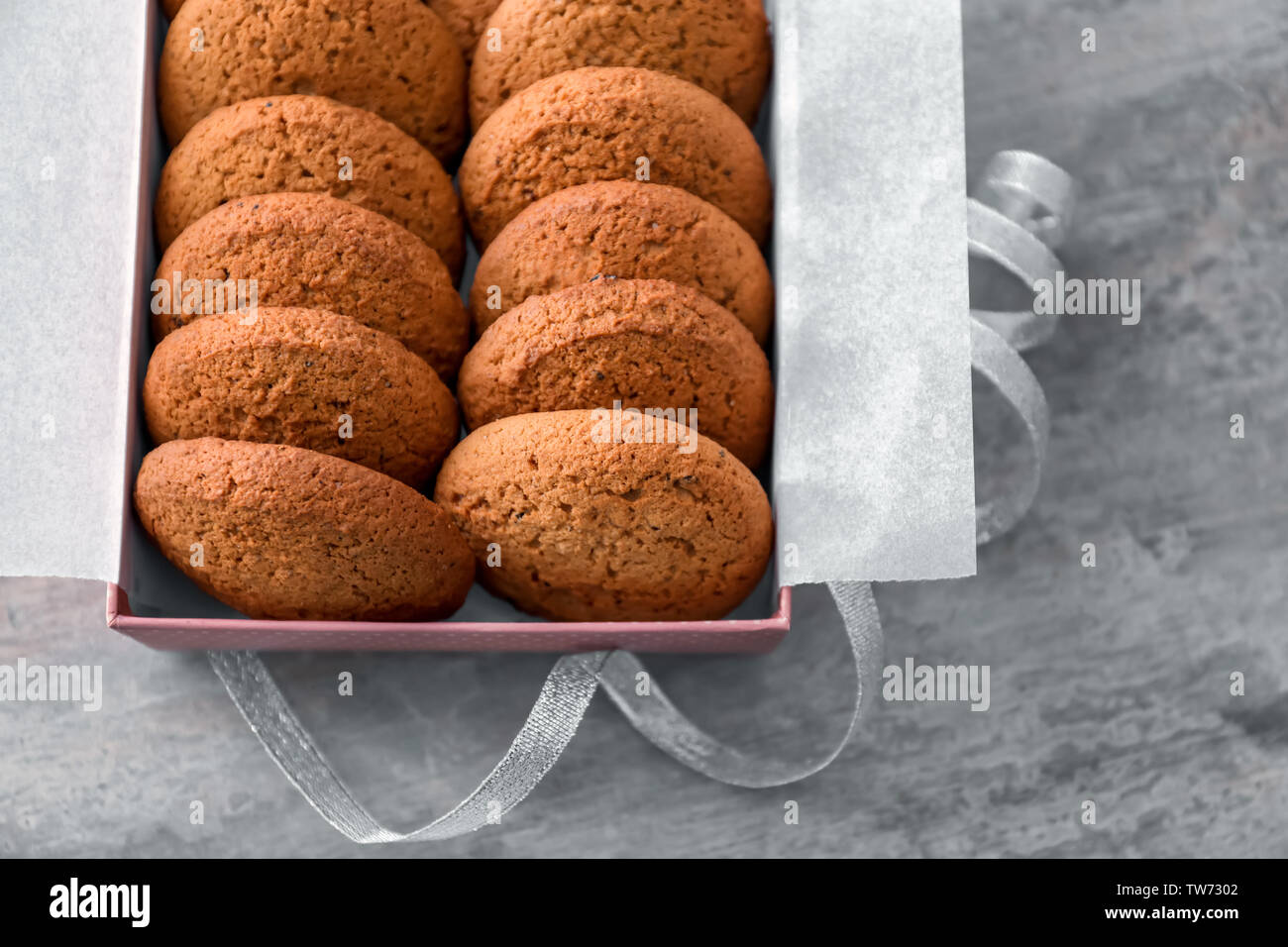 Box with delicious oatmeal cookies on table Stock Photo - Alamy