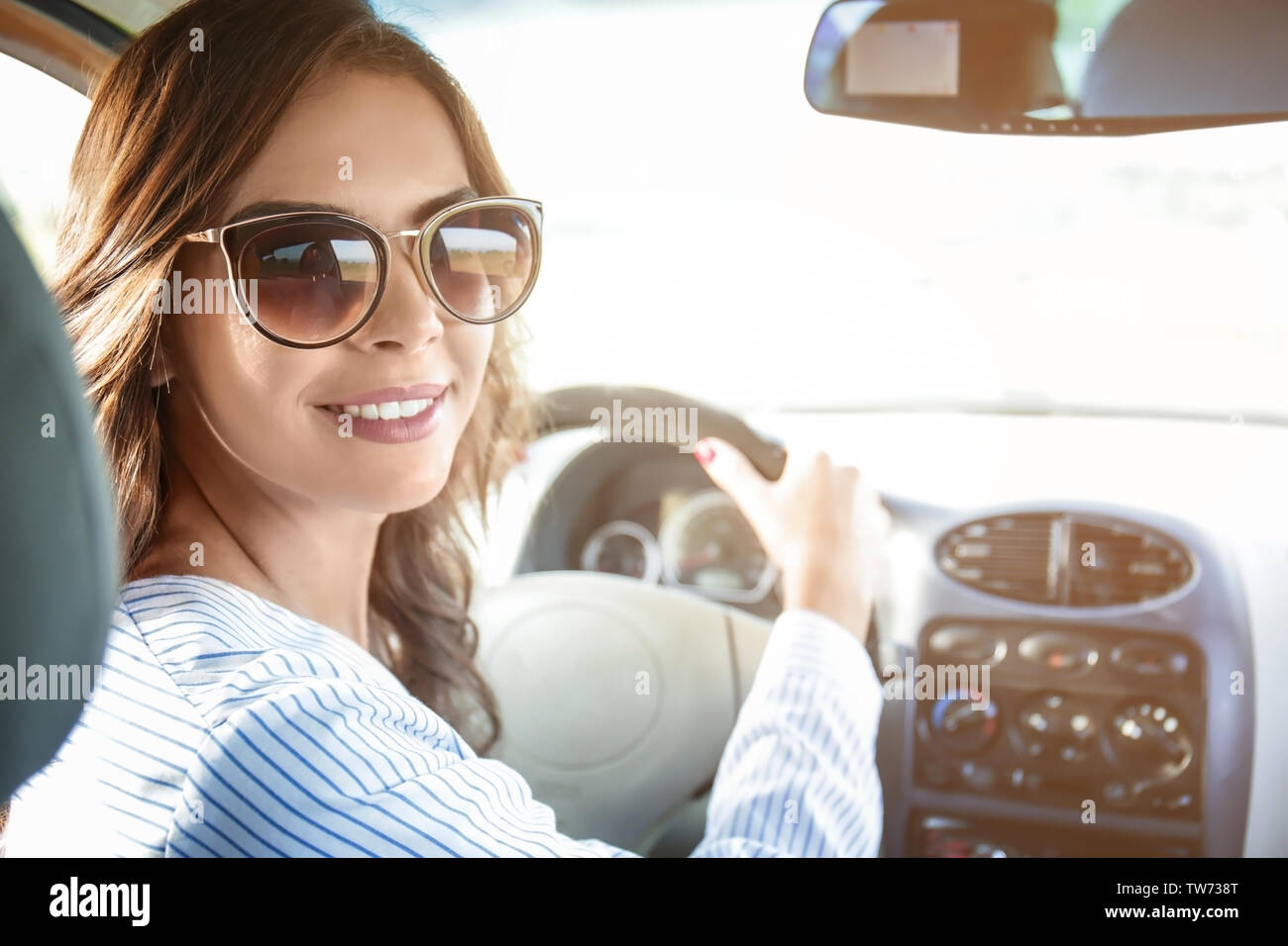 Beautiful young woman in car Stock Photo - Alamy