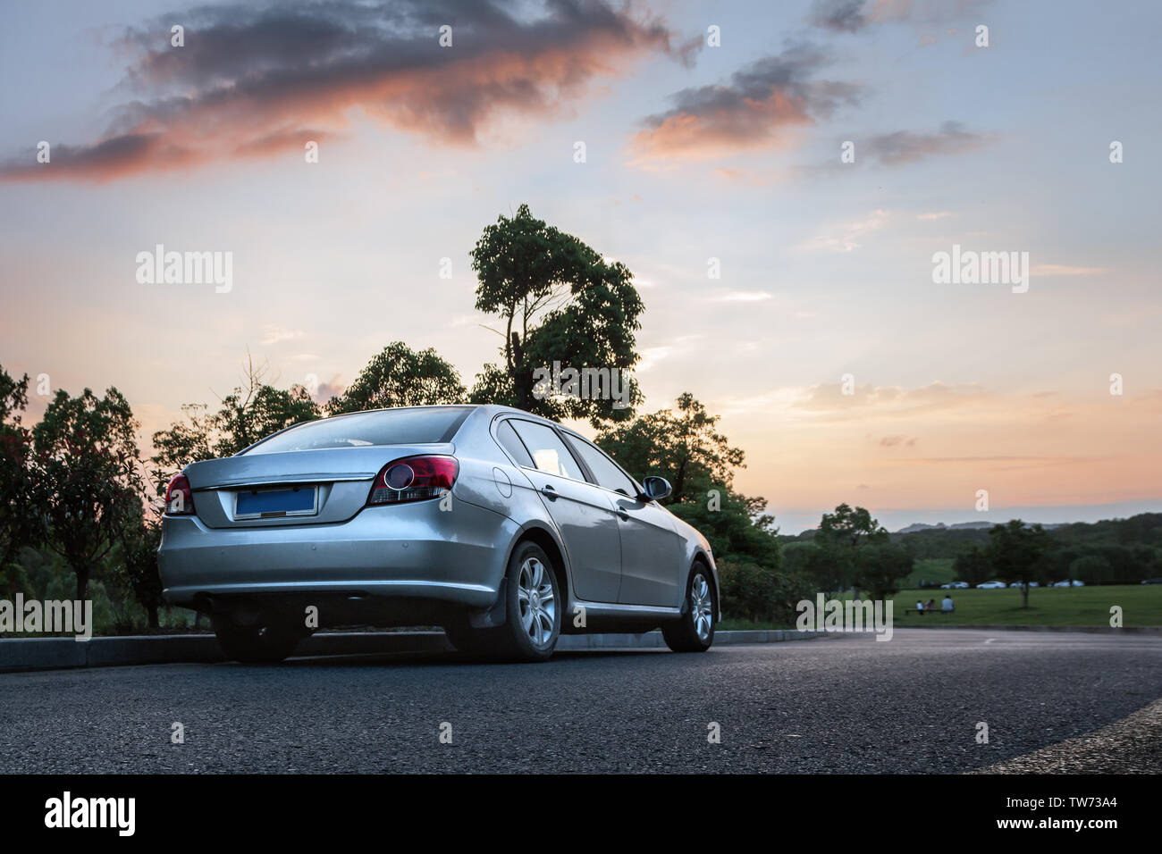 Car on sunset road Stock Photo - Alamy