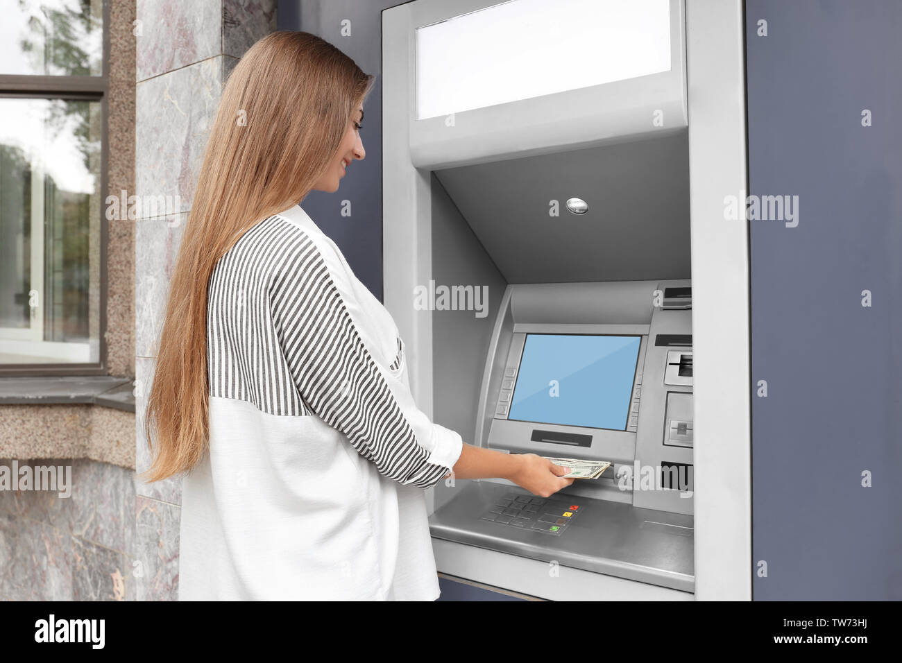 Taking money from cash machine hi-res stock photography and images - Alamy