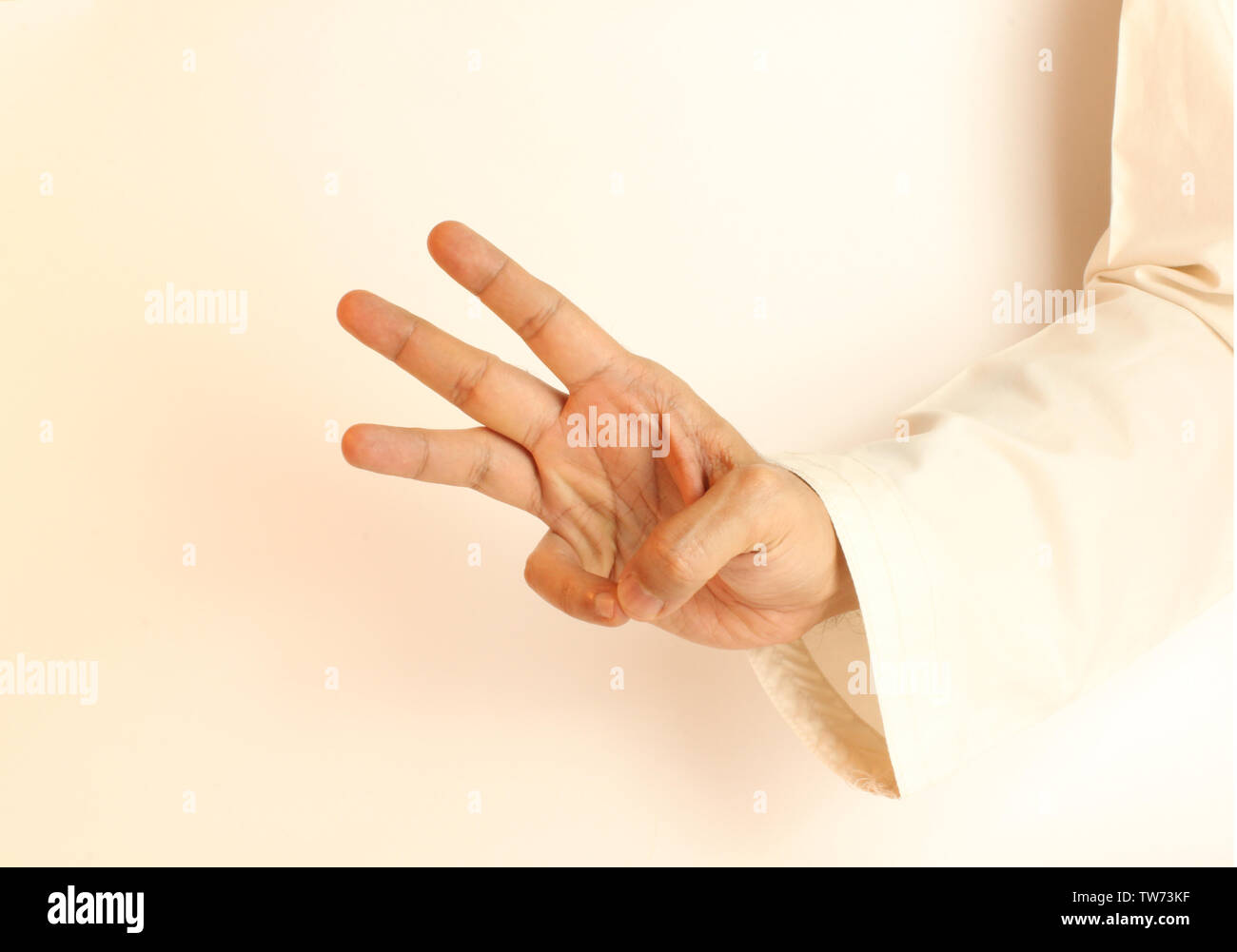 Arab Man wearing kandura Hand gesture series three light background ...