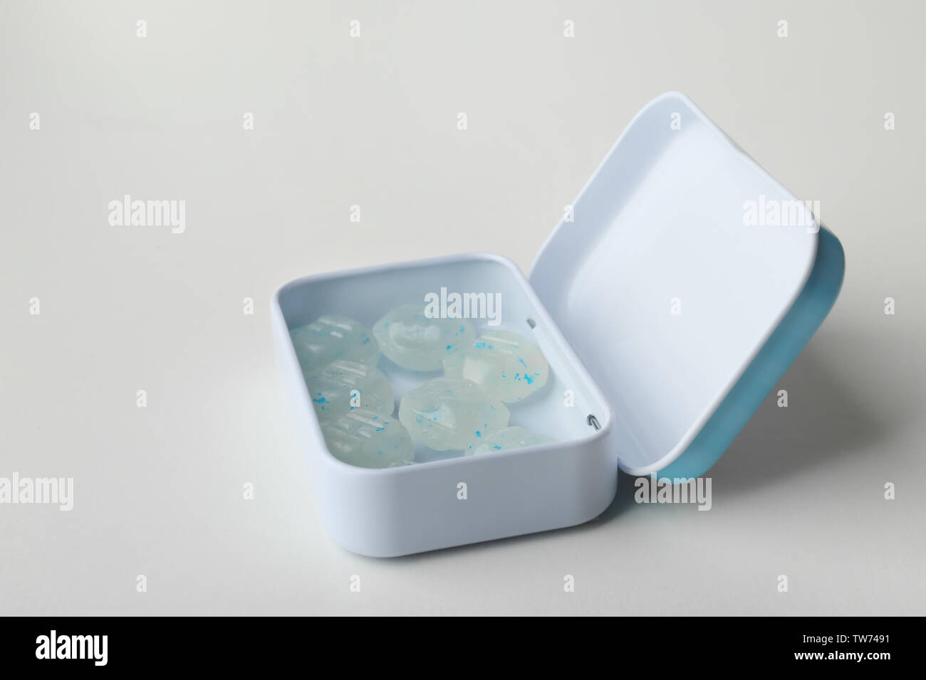 Open box with hard mint candies on light background Stock Photo - Alamy