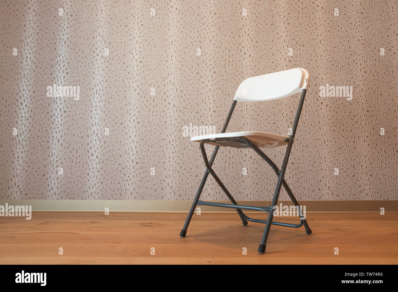 white empty chair in an empty room side view Stock Photo - Alamy