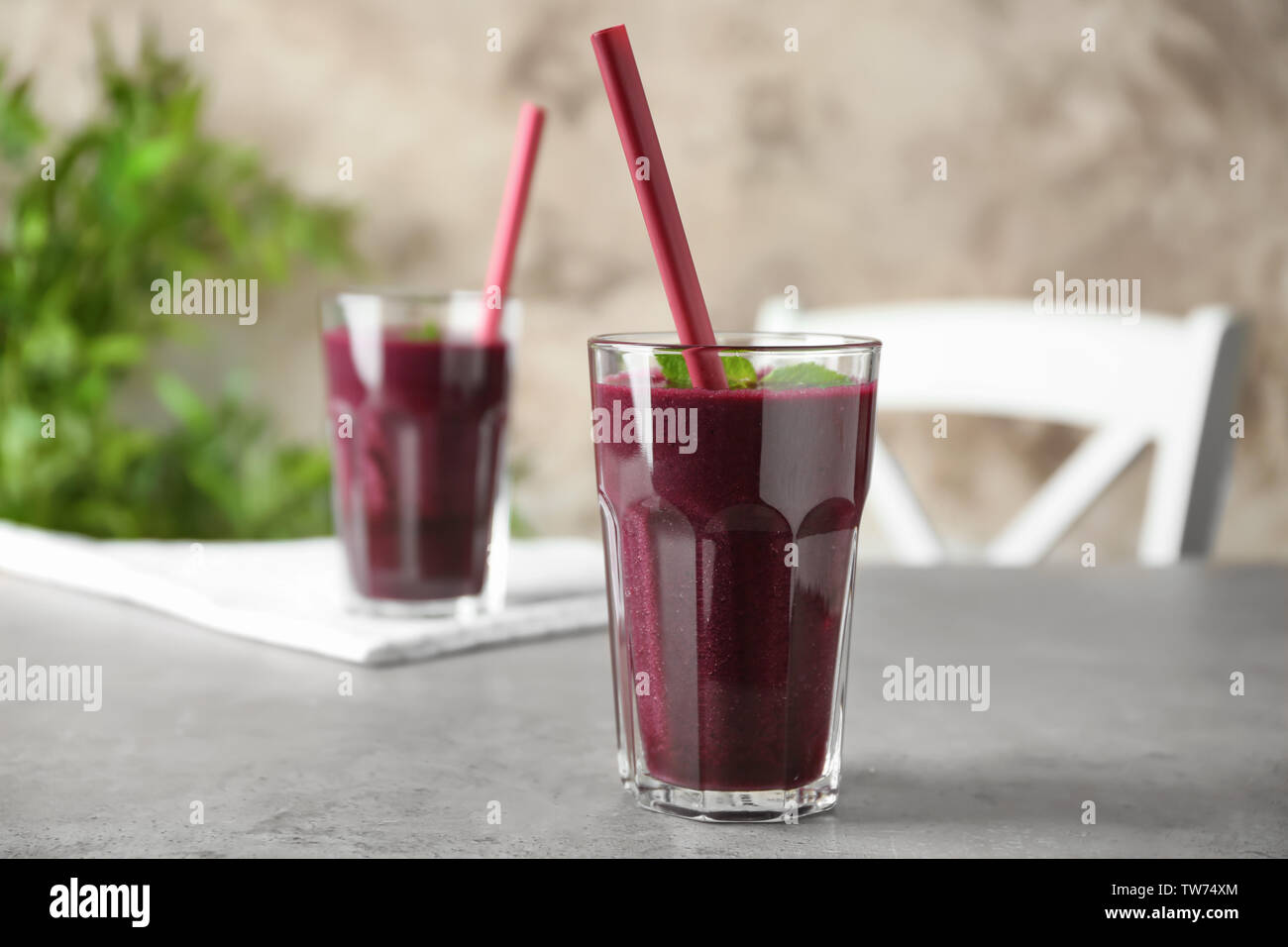 Glass with acai juice on table Stock Photo - Alamy