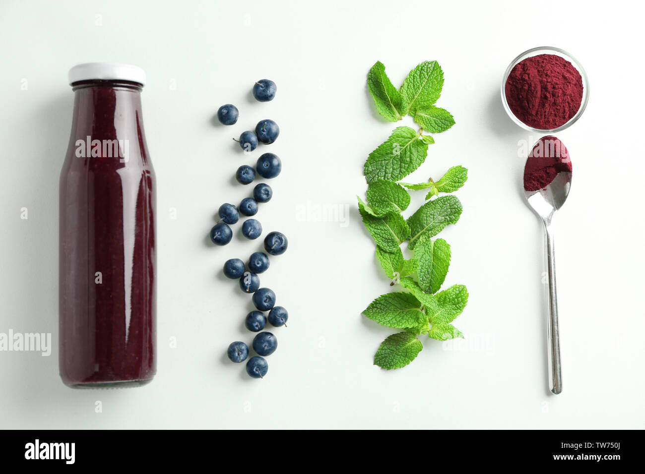 Composition with acai juice in glass bottle on light background Stock ...