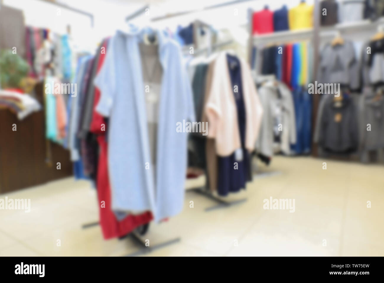 Blurred view of different clothes in modern store Stock Photo - Alamy