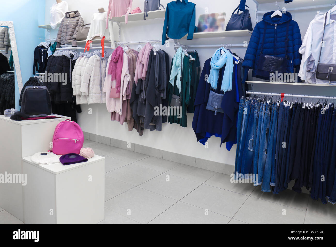 Different clothes in modern shop Stock Photo - Alamy