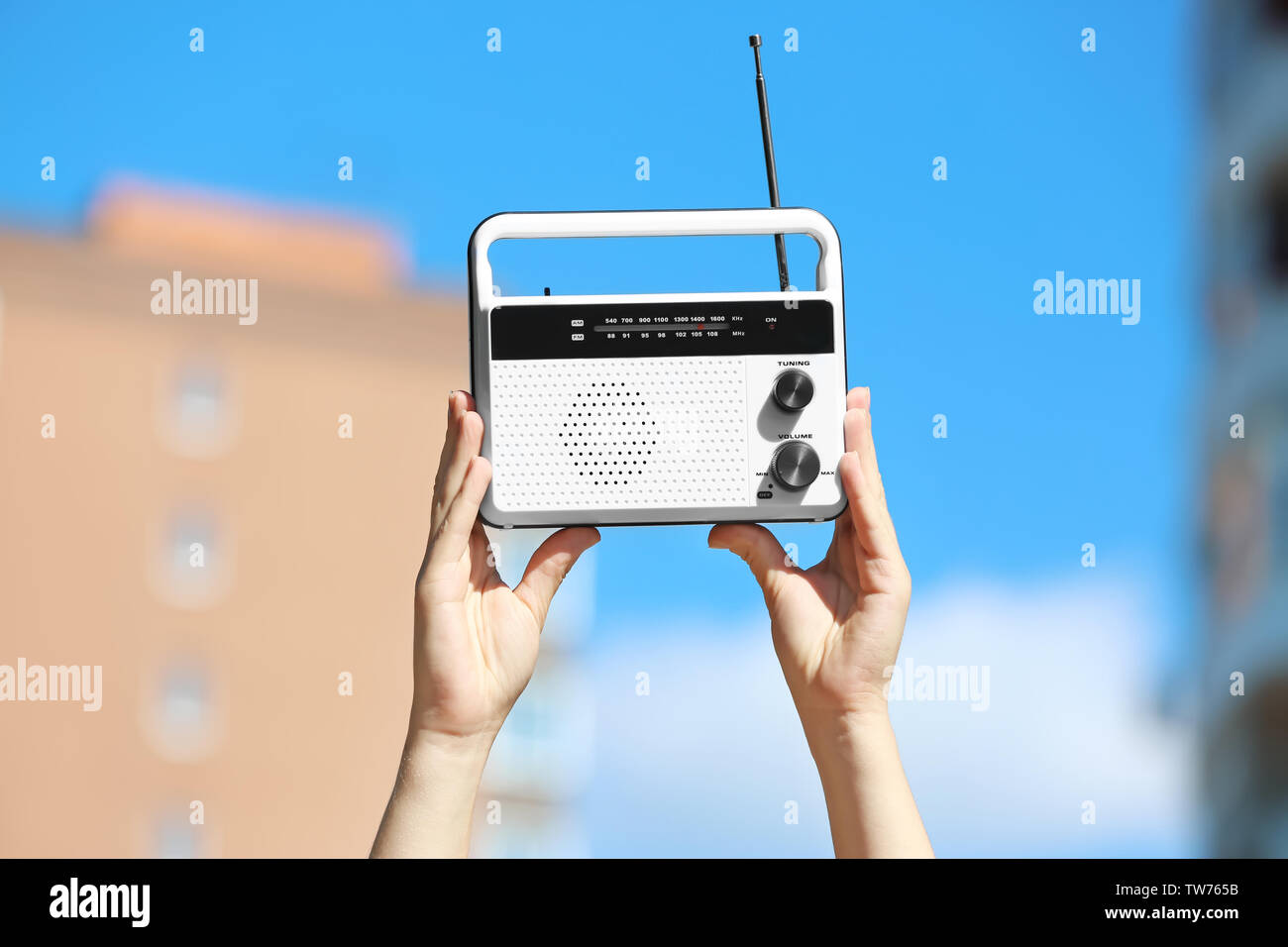 Woman holding radio, outdoors Stock Photo - Alamy