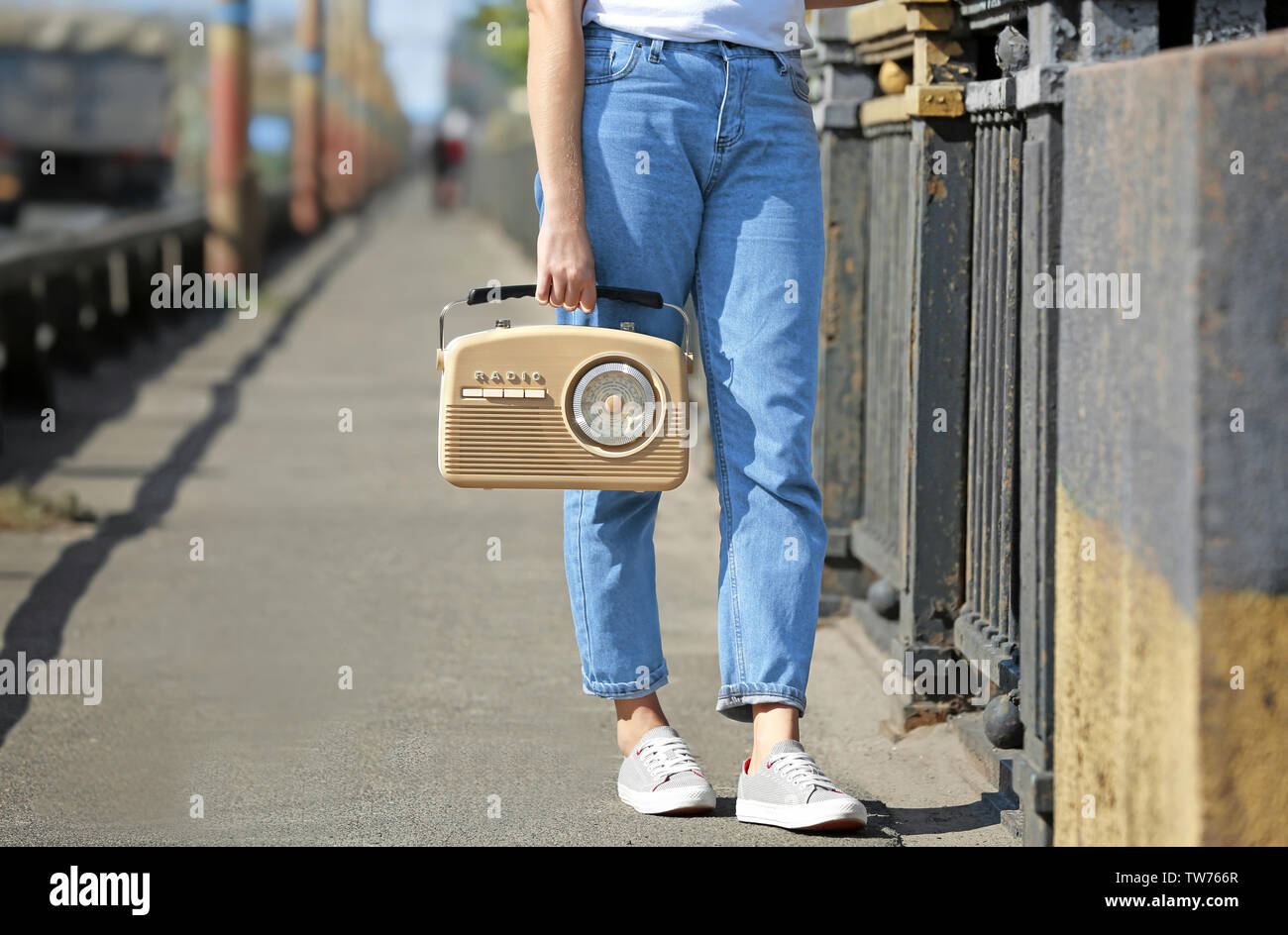 Woman holding radio, outdoors Stock Photo - Alamy