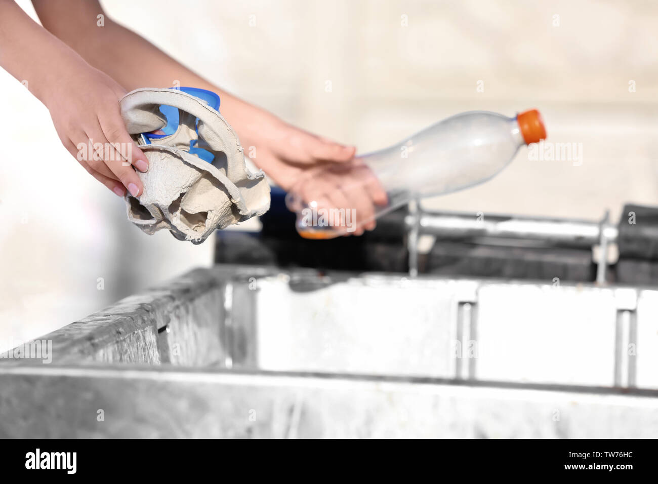 Person throwing garbage in metal container outdoors, closeup Stock ...