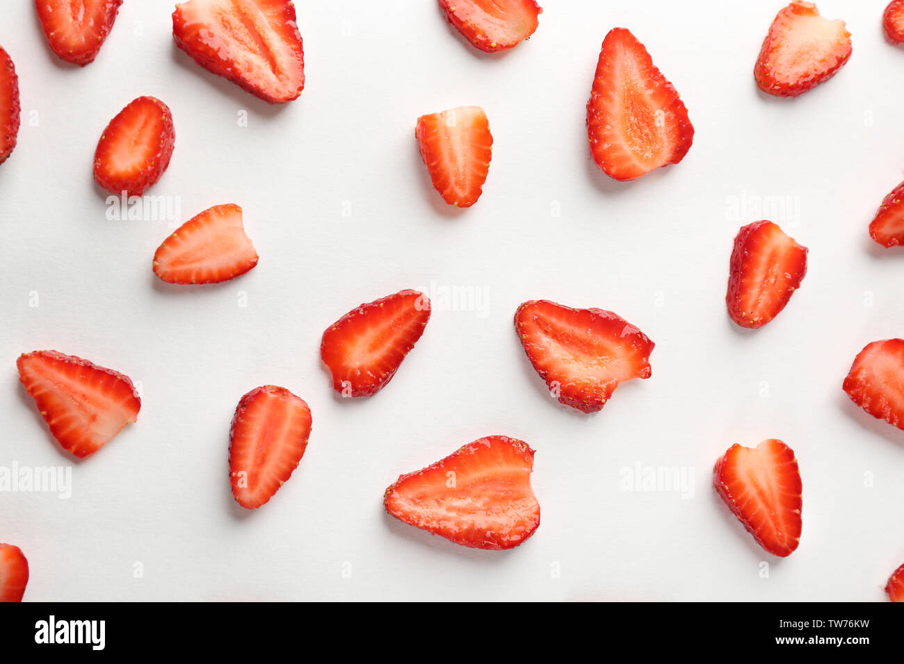 Fresh strawberry slices on white background Stock Photo - Alamy