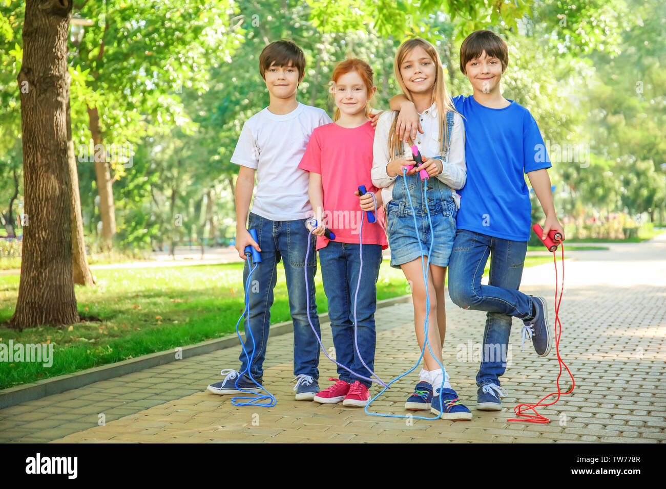 Cute little children with jumping ropes in park Stock Photo - Alamy