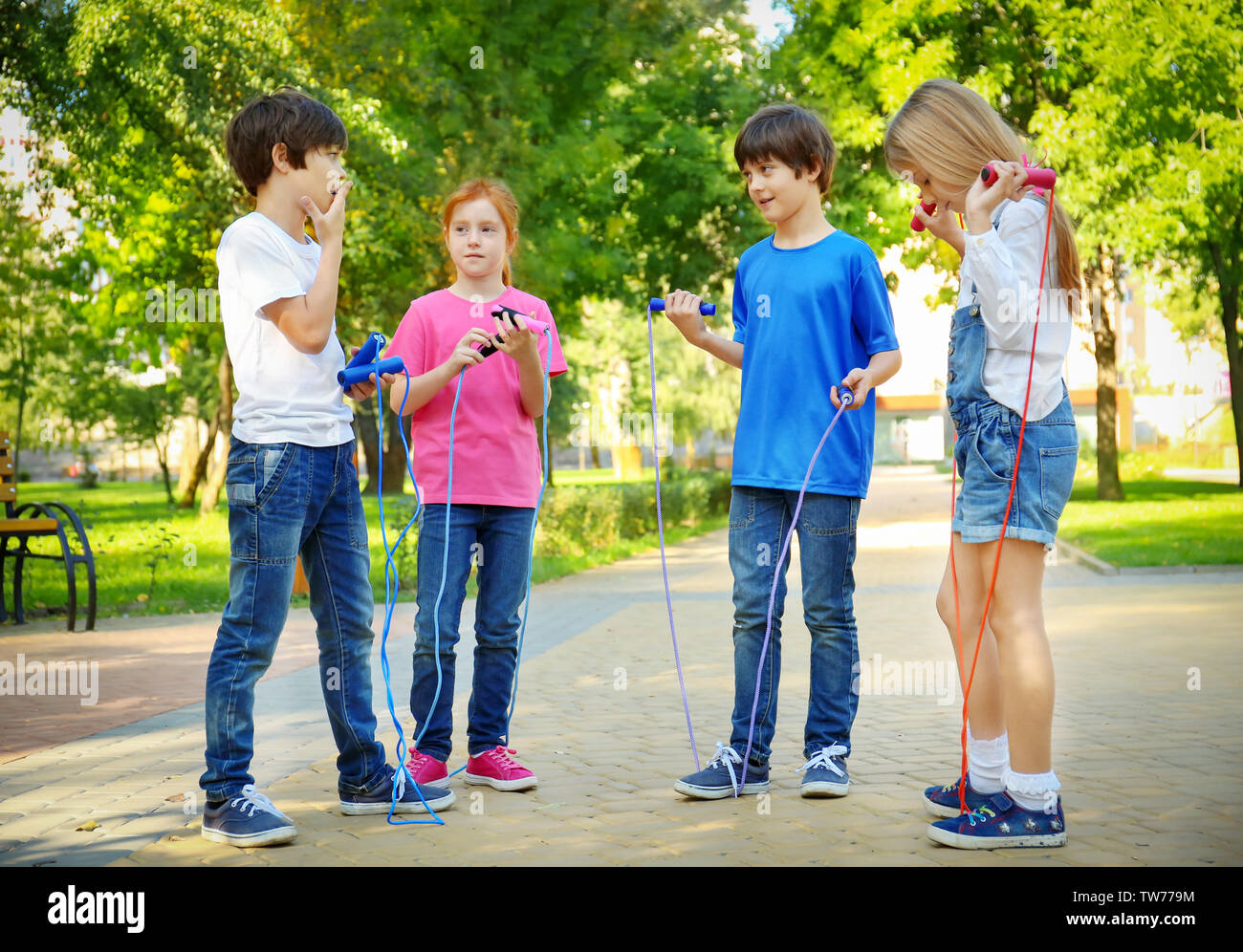 Cute little children with jumping ropes in park Stock Photo - Alamy