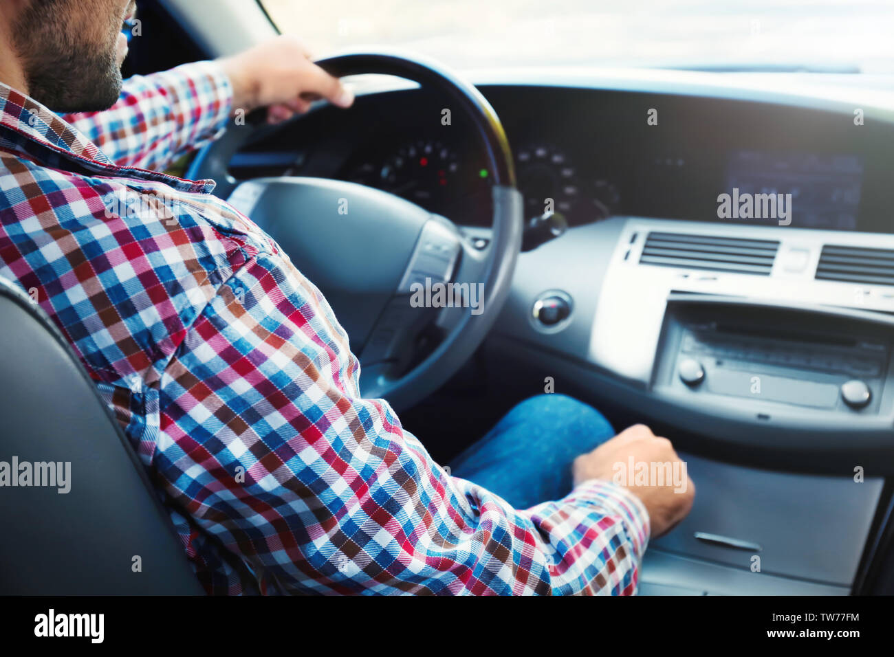 Young man on driver seat of car Stock Photo - Alamy