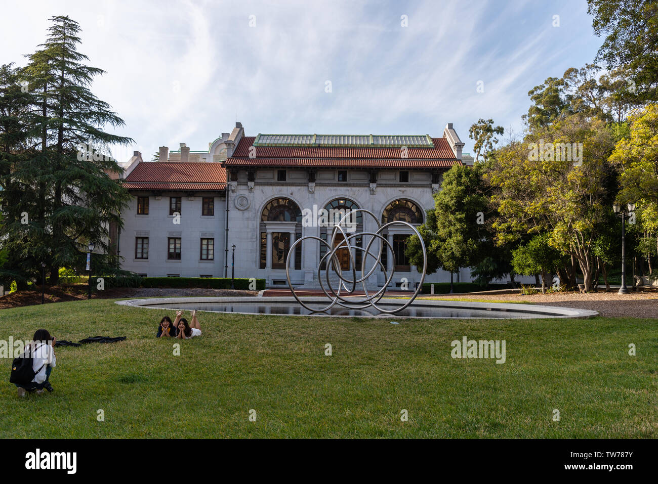 Girls taking picture in front of building in the campus of University ...