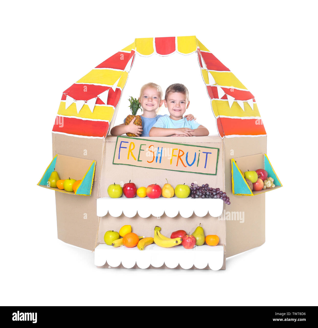 Little children playing with cardboard stall on white background Stock ...