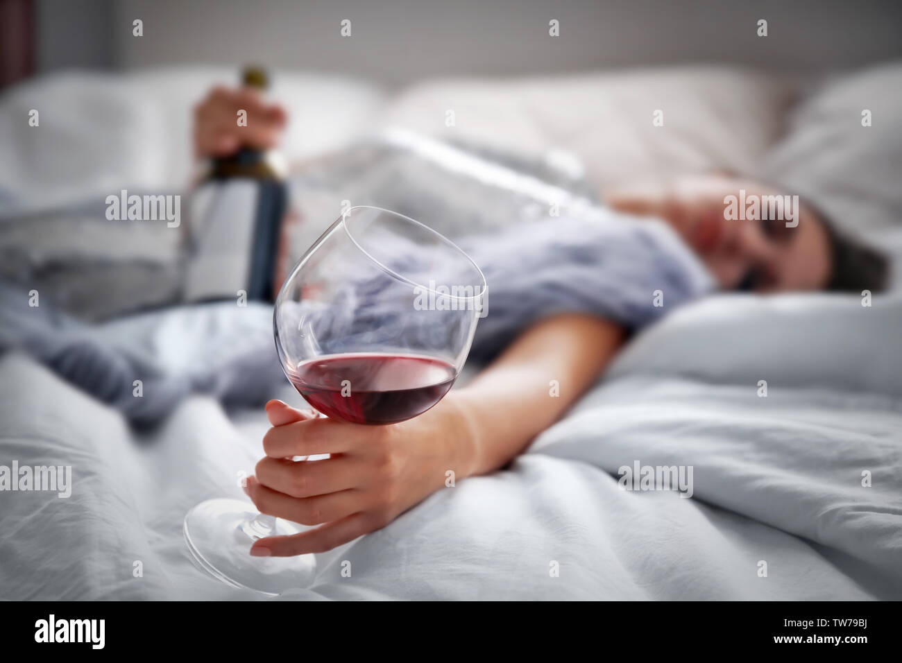 Young woman drinking alcohol at home Stock Photo - Alamy
