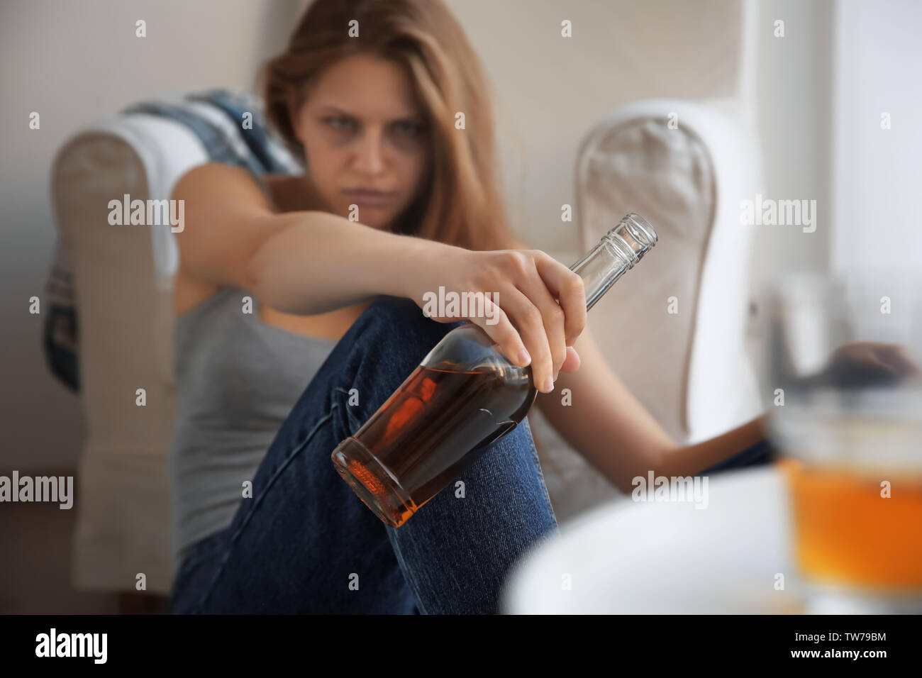 Young woman drinking alcohol at home Stock Photo - Alamy