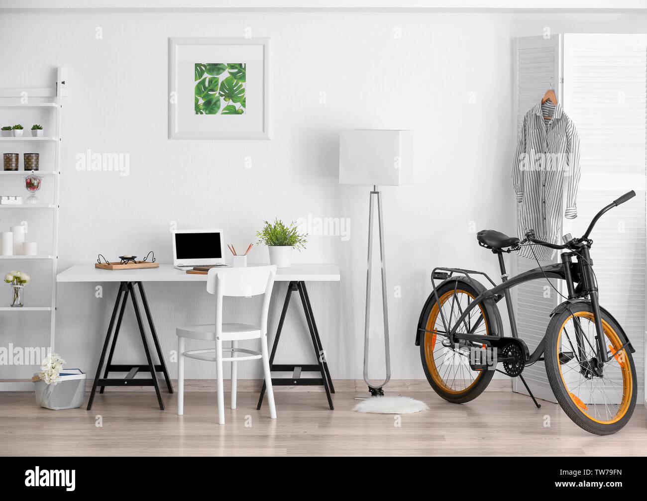 Modern room interior with bicycle and workplace Stock Photo - Alamy