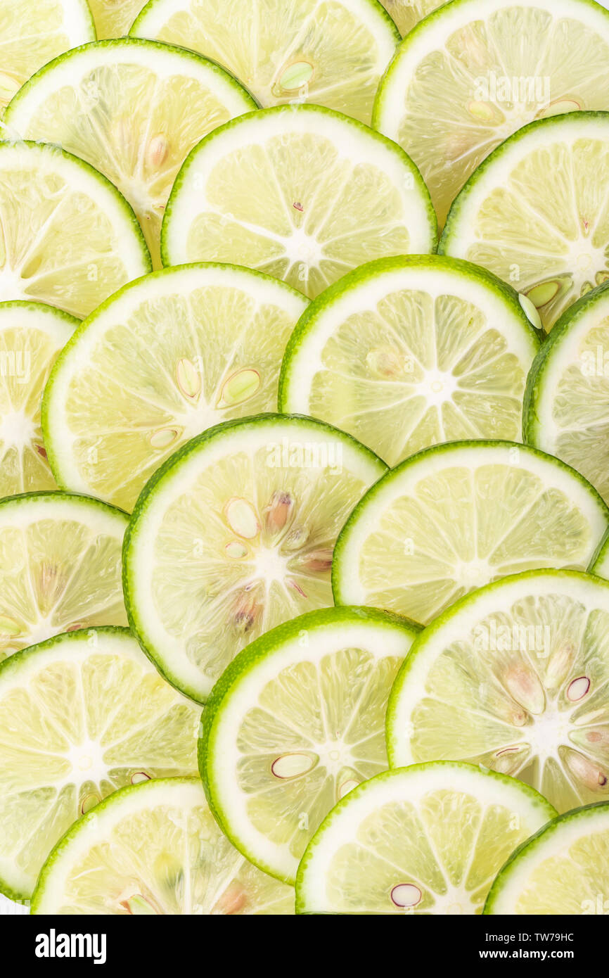 Green lemon slices on white background Stock Photo - Alamy