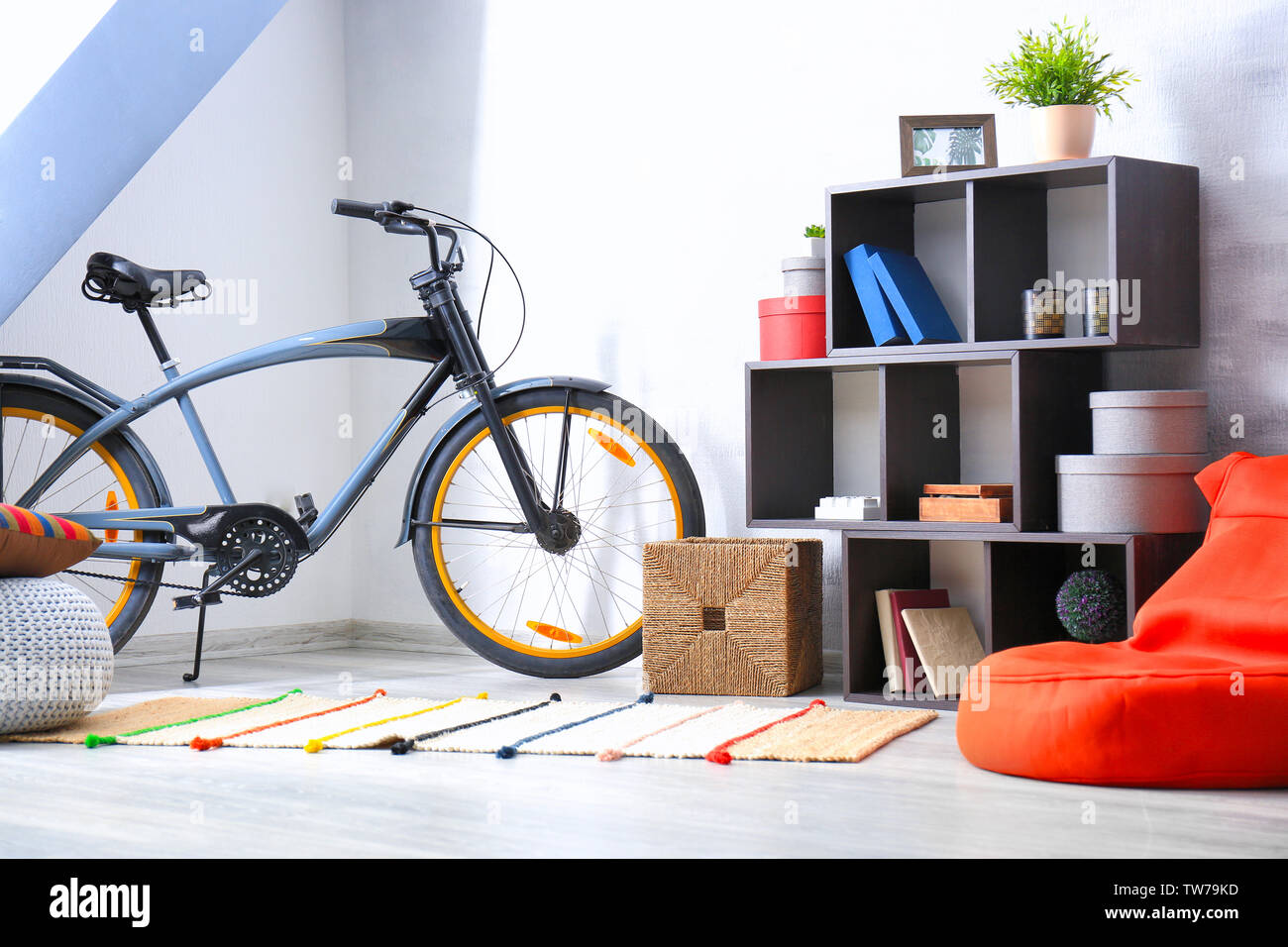 Modern room interior with bicycle and shelving unit Stock Photo - Alamy